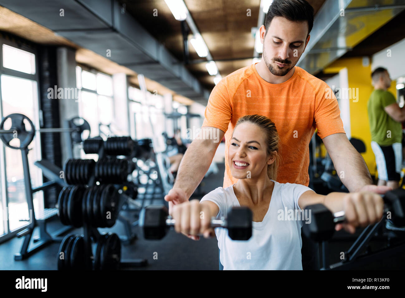 Personal trainer giving instructions in gym Stock Photo - Alamy