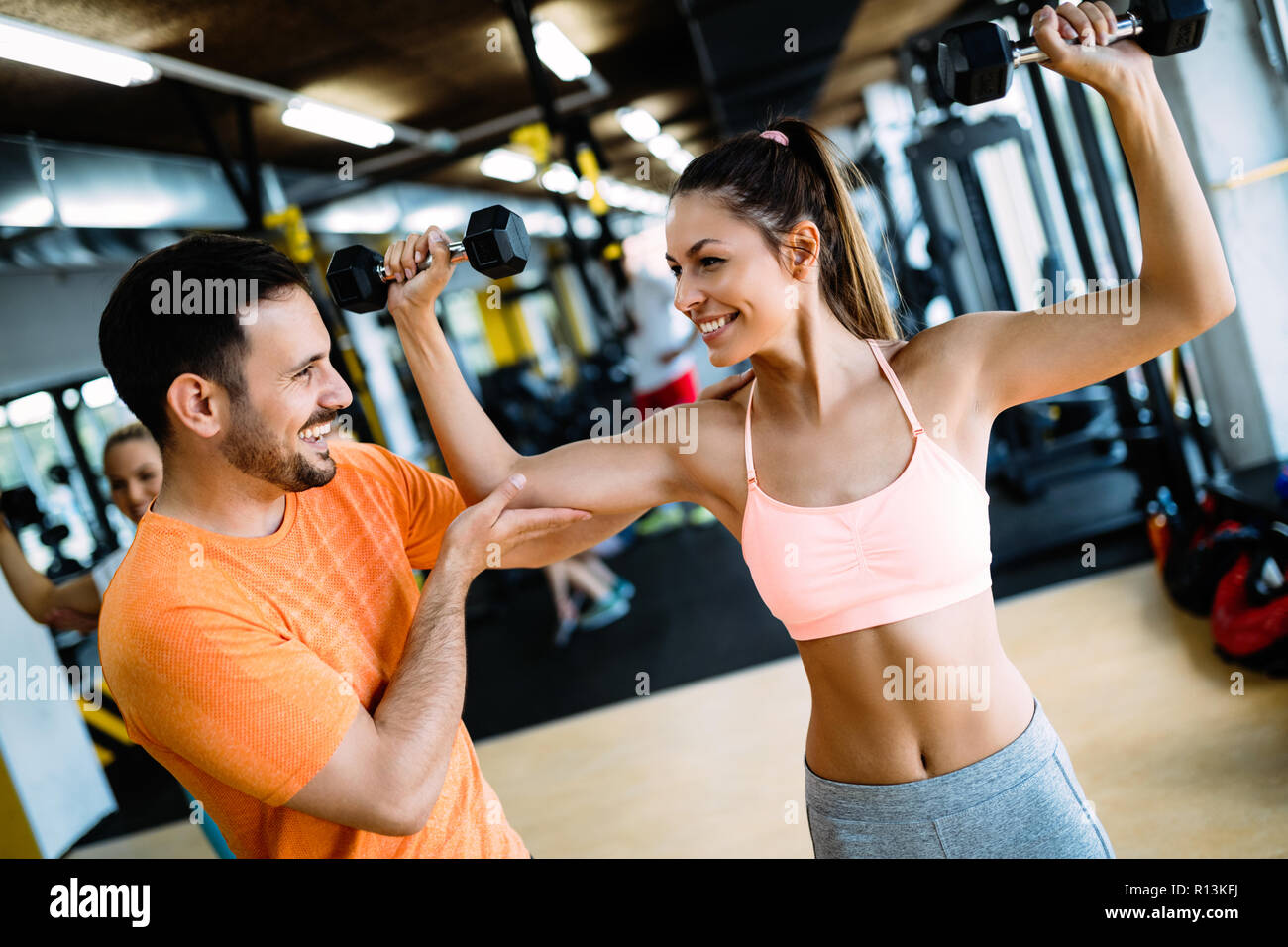 Personal trainer instructing trainee Stock Photo - Alamy