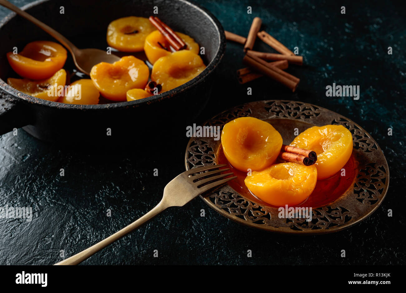 Peach dessert with cinnamon and cloves on a dark background Stock Photo ...