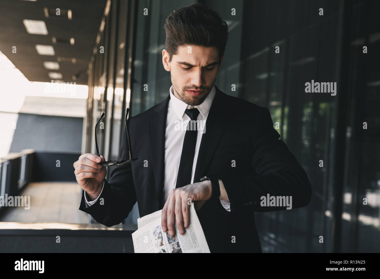 Image of handsome business man near business center looking holding ...