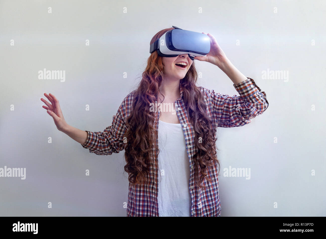 Smile young woman wearing using virtual reality VR glasses helmet ...