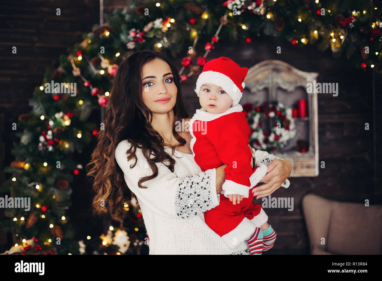 Lovely mother rising up her baby and smiling to each other Stock Photo ...