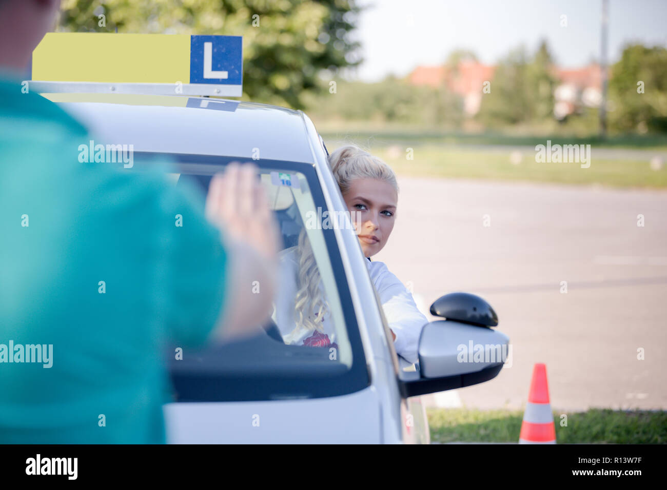 Driving school. Young woman or driving student with instructor learning ...