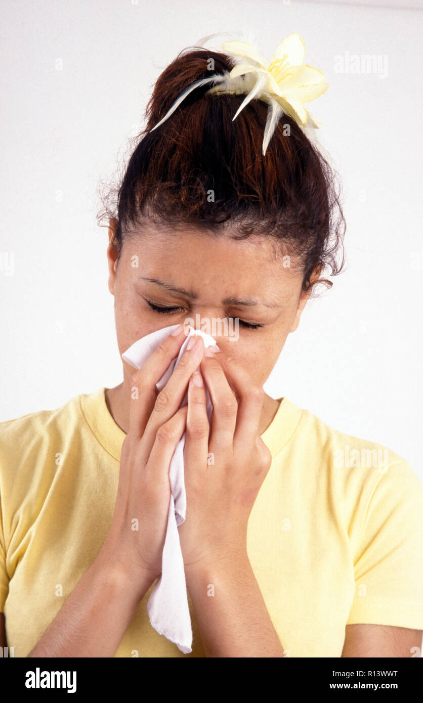 young girl blowing her nose Stock Photo - Alamy