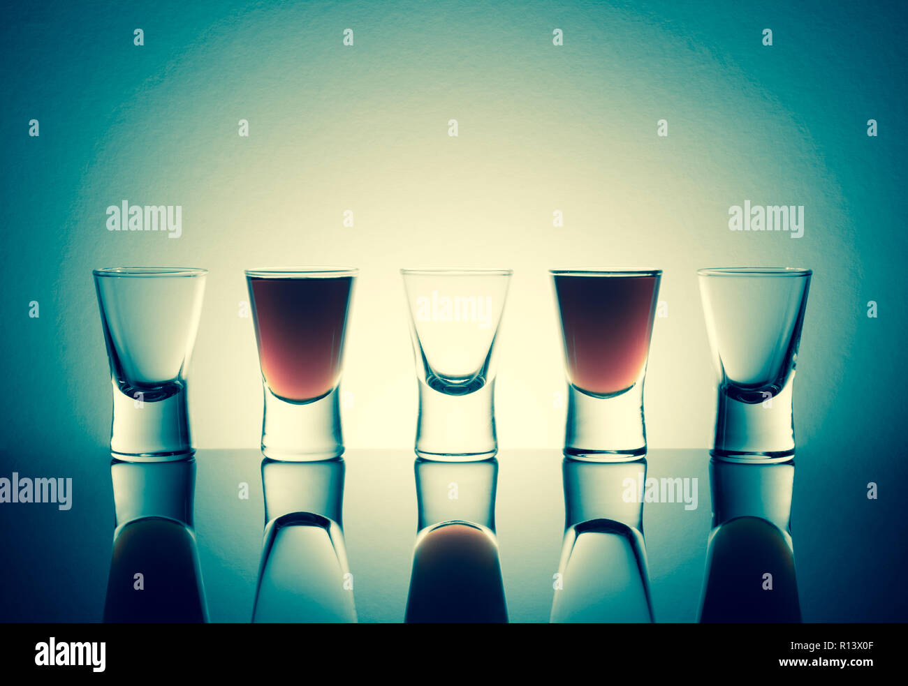 small glasses with a drink shots of alcohol stainding in a table with ...