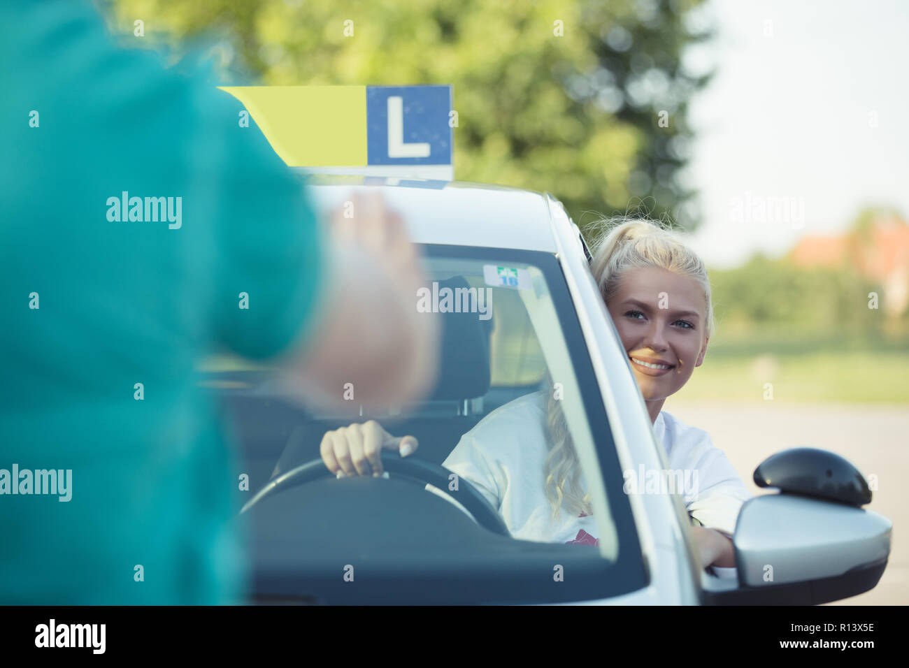 Driving school. Young woman or driving student with instructor learning ...