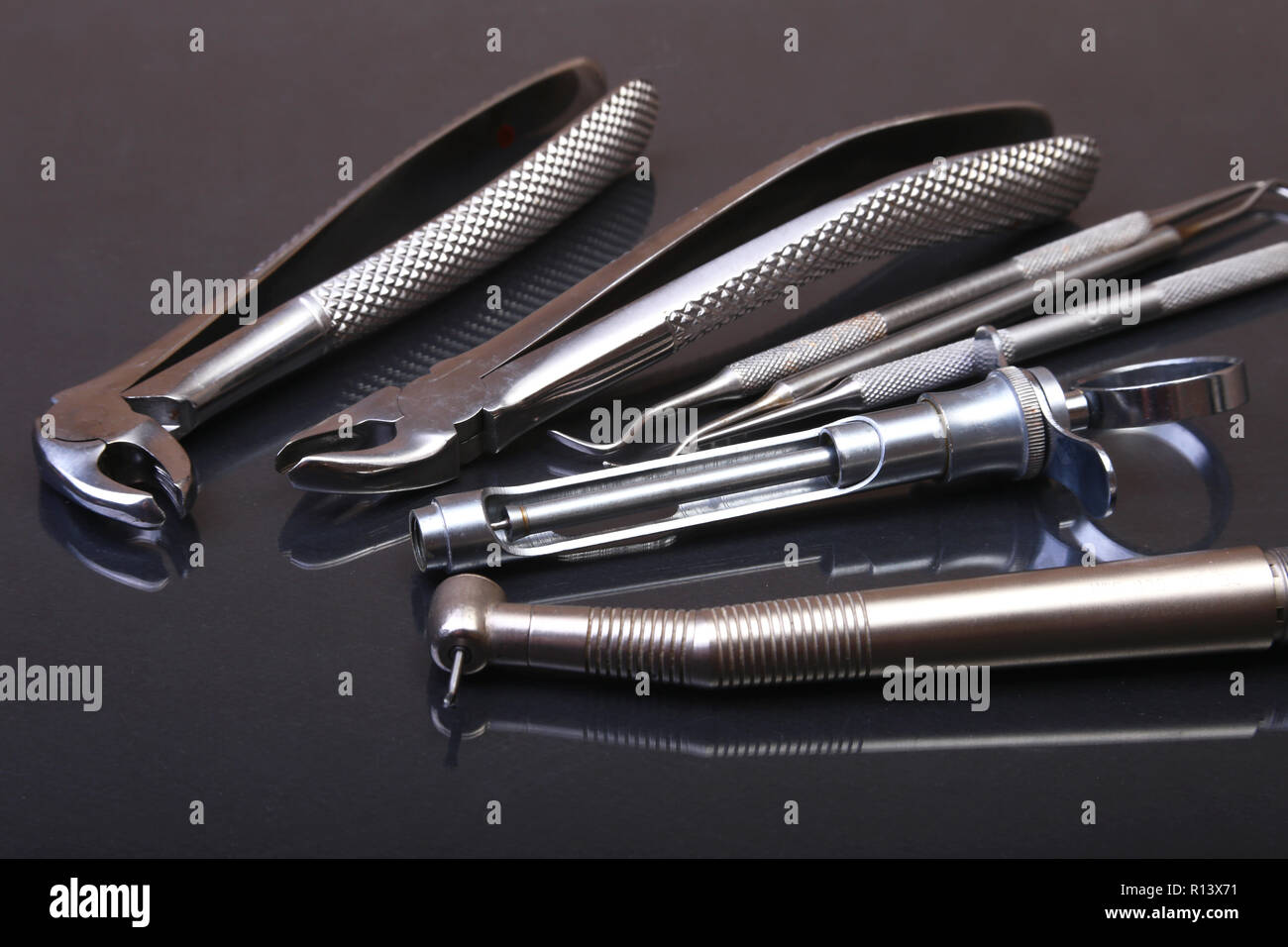 Set of metal medical equipment tools for teeth dental care on black ...