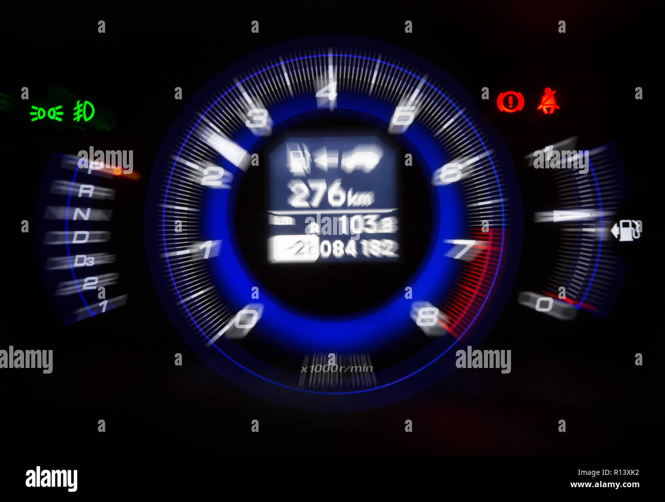 Closeup modern automotive tachometer on black background, motion blur ...