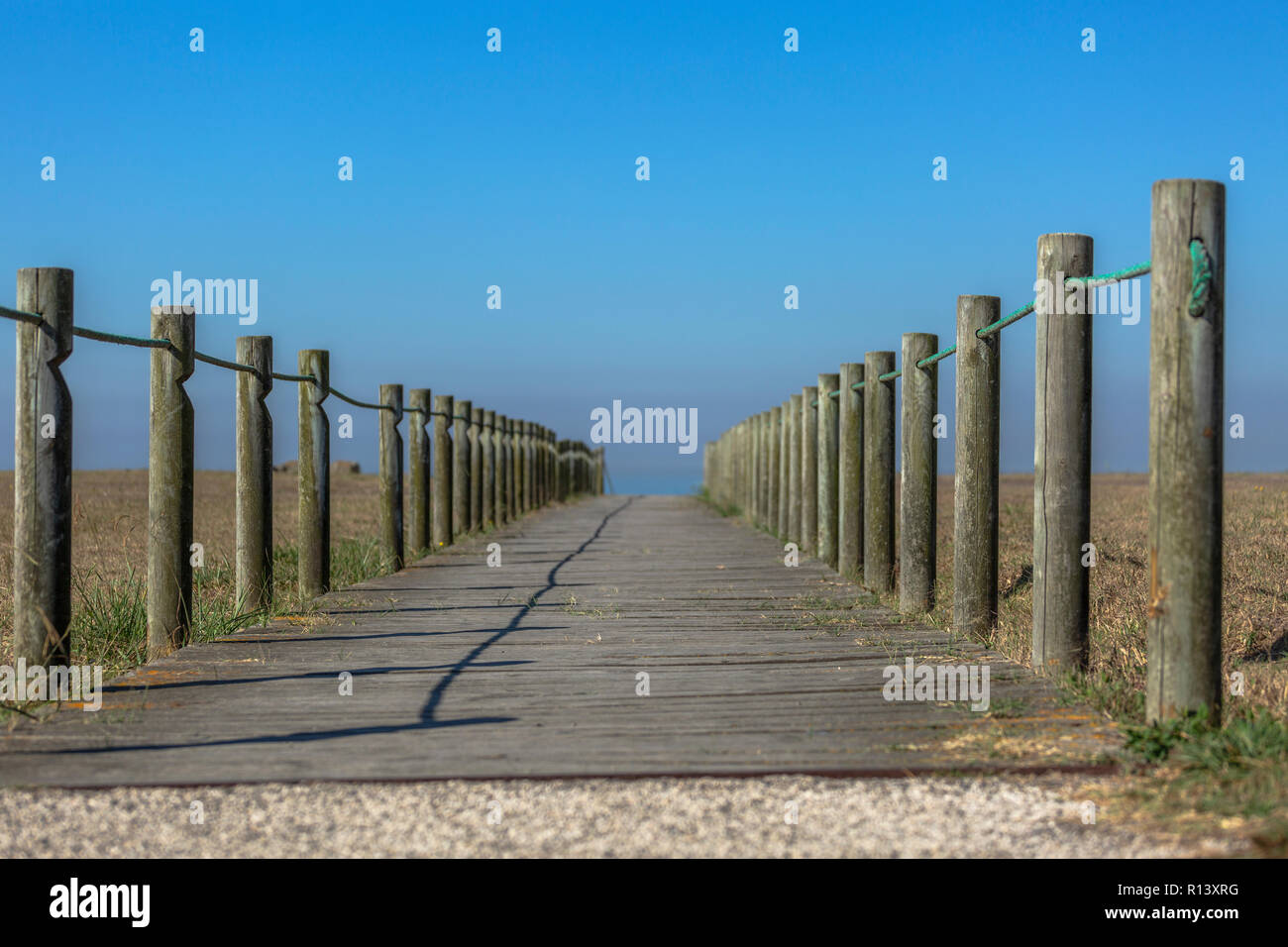 Perspective view of wooden pedestrian walkway, towards the ocean, next ...