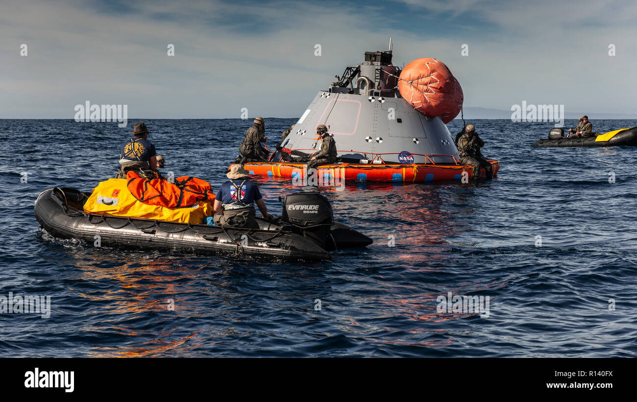 U.S. Navy divers attach the float collar to the mock up version of the ...