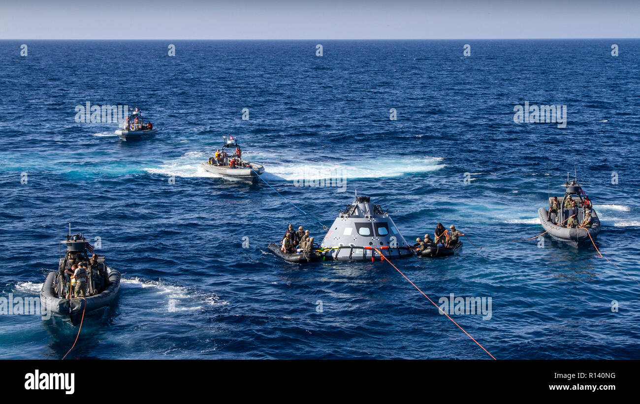 U.S. Navy divers perform a cable to the mock up version of the NASA ...