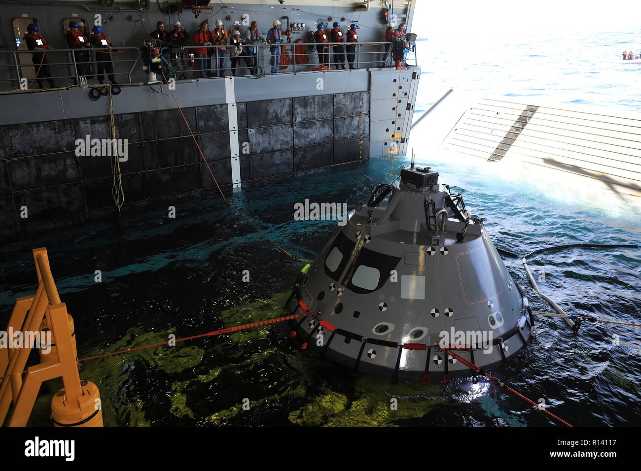 NASA recovery team and U.S. Navy divers pull a mock up version of the ...