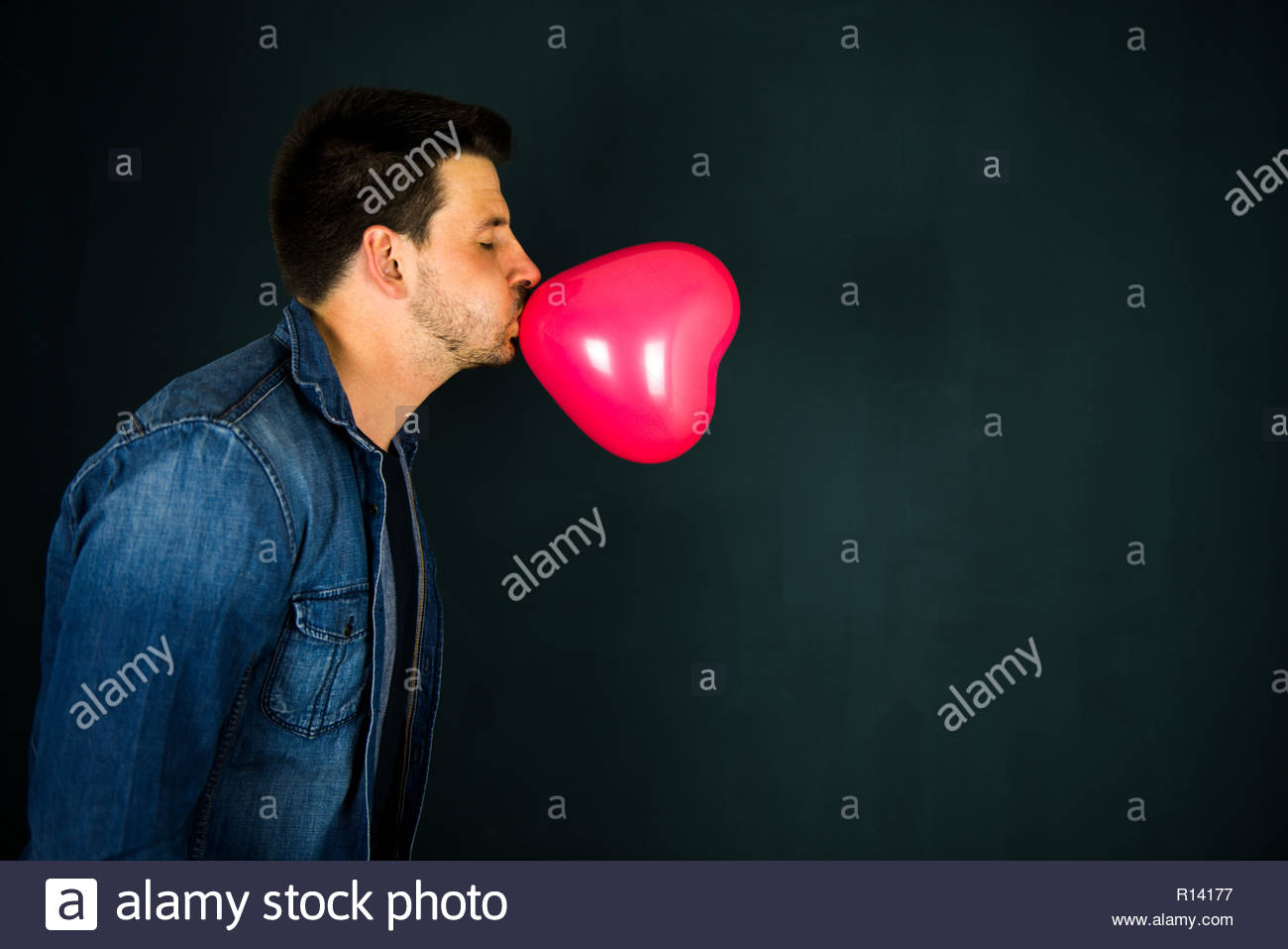 Man Blowing Up Balloon Stock Photos & Man Blowing Up Balloon Stock ...