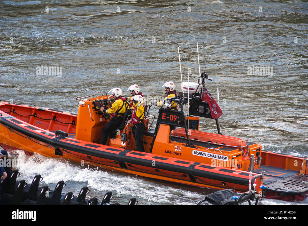 RNLI inshore rib lifeboat with four personnel speeding along the River ...