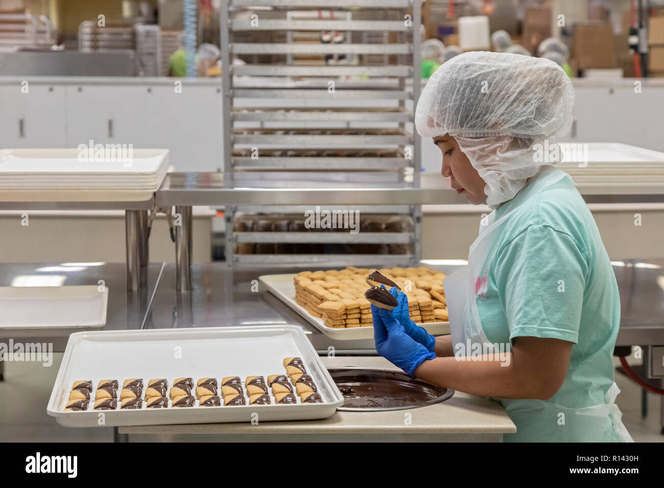 Hilo, Hawaii - Workers make Macadamia Nut Shortbread dipped in milk ...