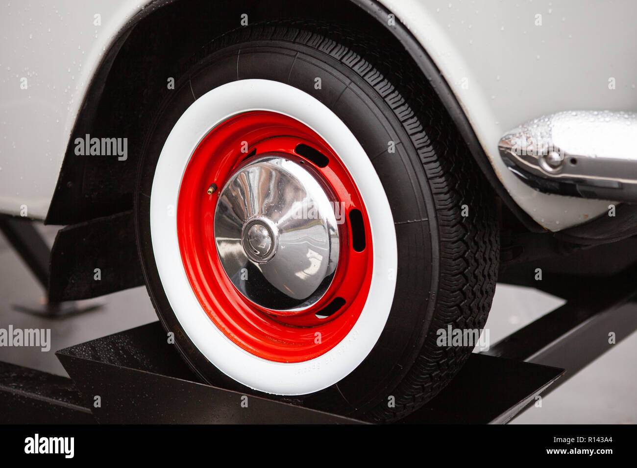 Vintage car wheel, painted red, the concept of the history of the ...