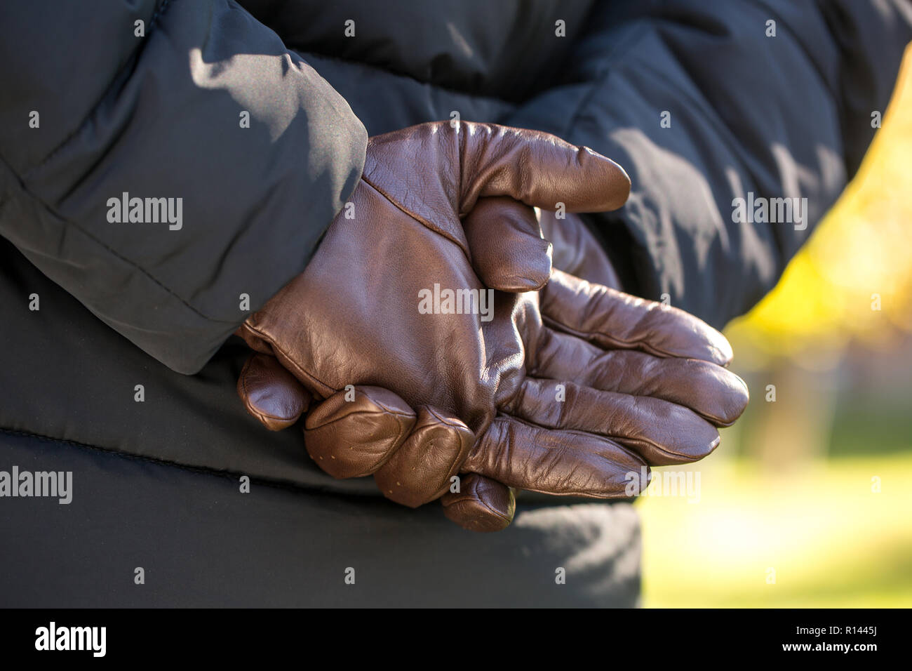 Hands behind back gloves hi-res stock photography and images - Alamy