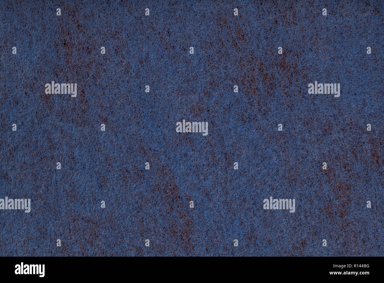 Construction of a navy blue background with brown spots of felt fabric ...