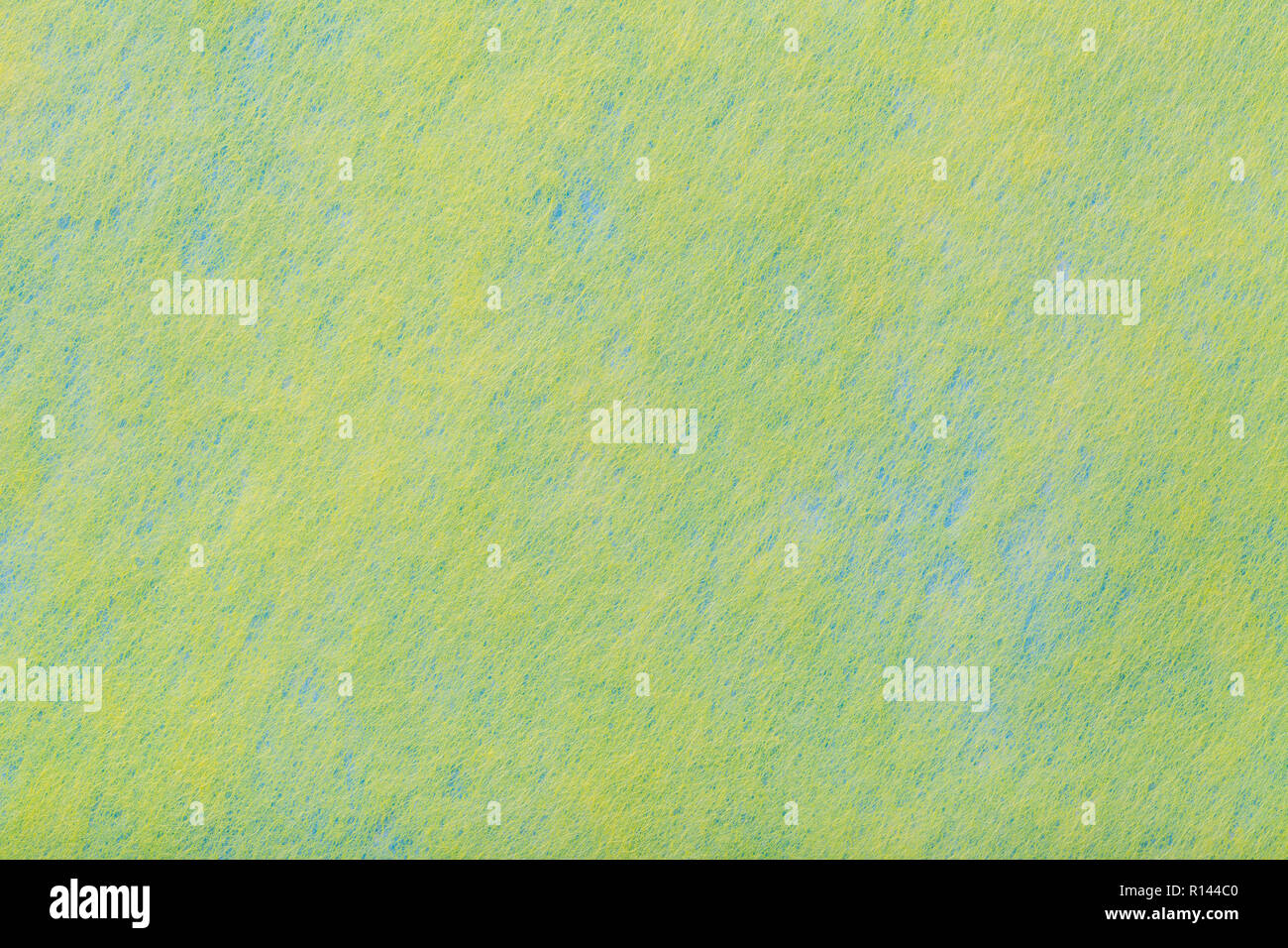 Construction of a light green background with blue spots of felt fabric ...