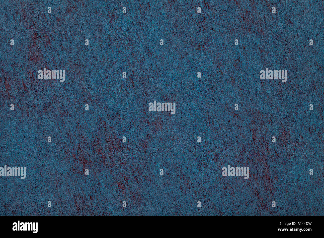 Construction of a navy blue background with brown spots of felt fabric ...
