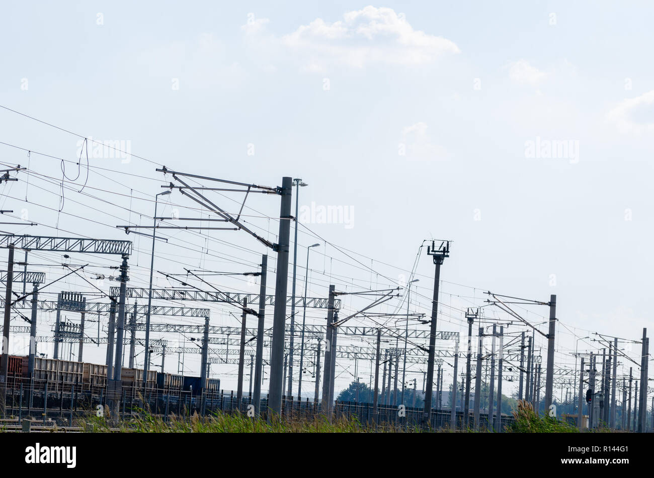 Tram wires (overhead lines, railroad trolley line)and masts on the sky ...