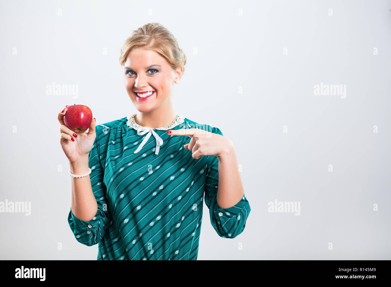 Healthy woman pointing apple hi-res stock photography and images - Alamy