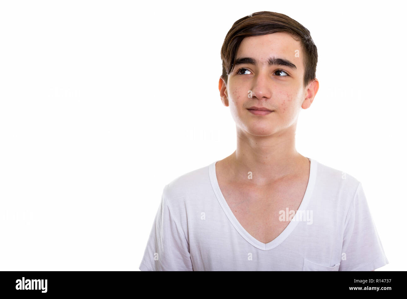 Studio shot of young handsome Persian teenage boy thinking Stock Photo ...