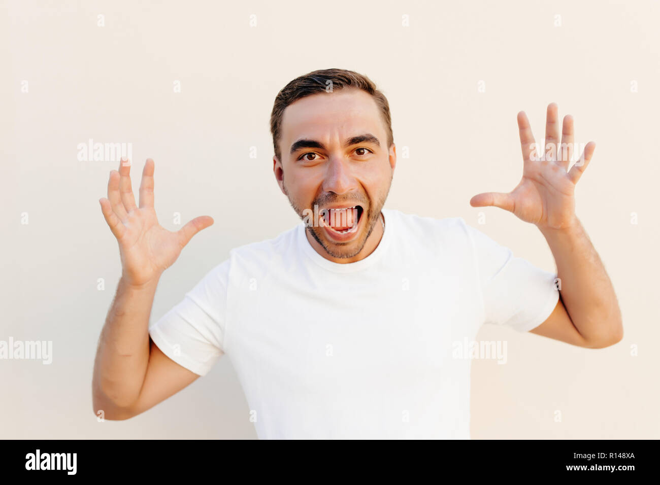 Screaming, hate, rage. Crying emotional angry man screaming on orange ...