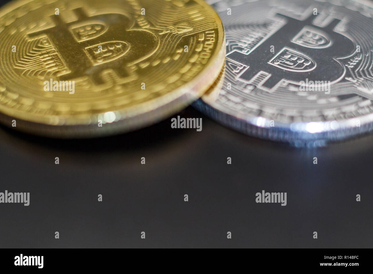 Silver and golden bitcoin on black background Stock Photo - Alamy