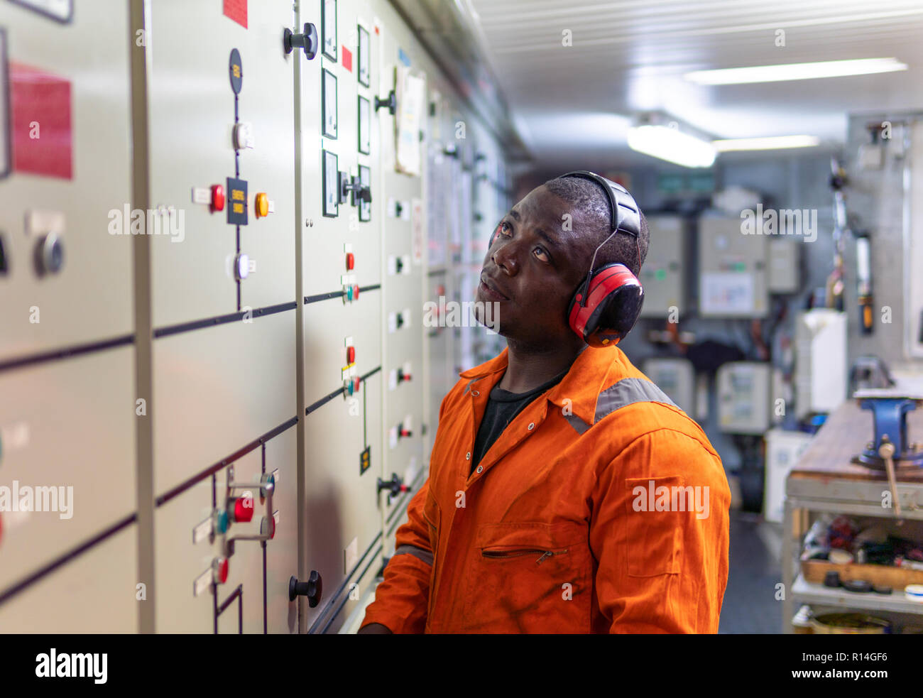 Marine engineer officer working in engine room Stock Photo - Alamy