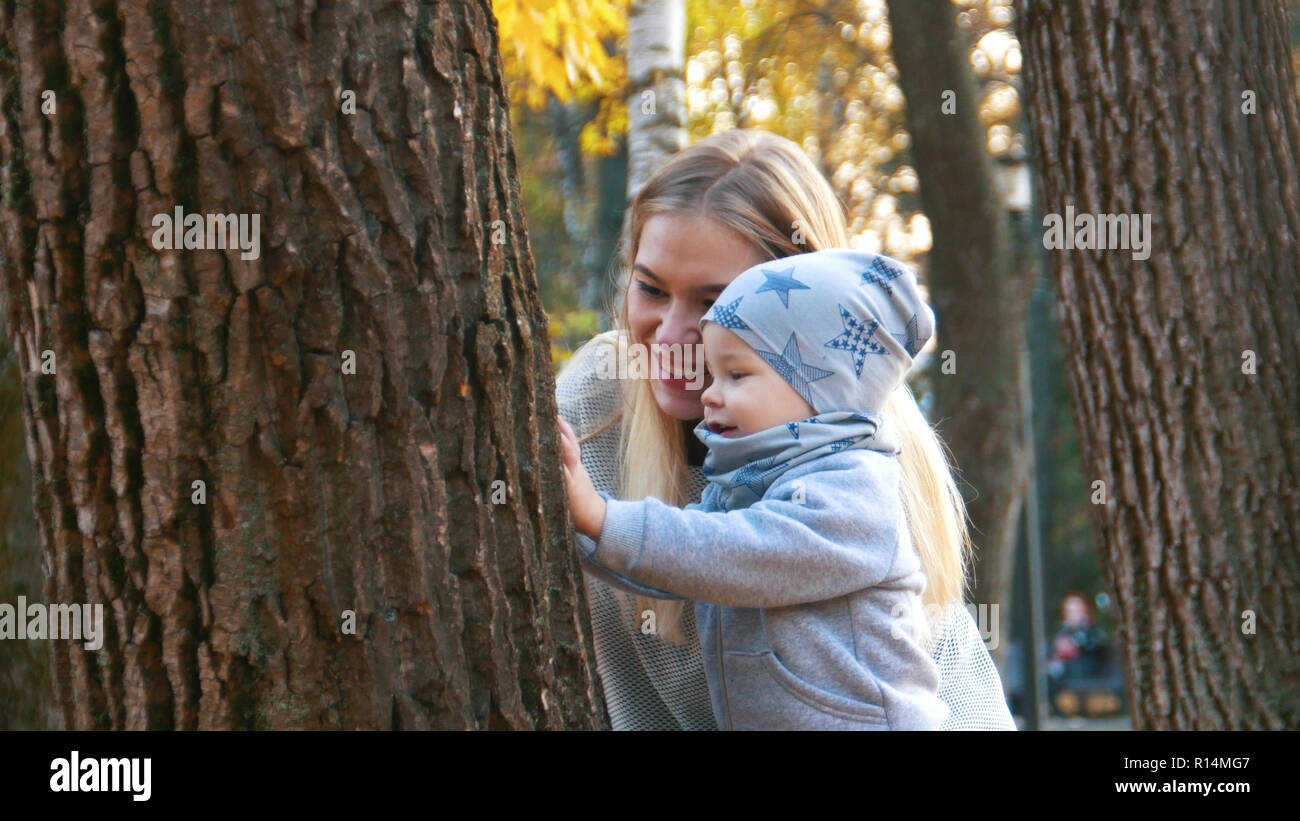 Young mother and her little baby looking at the tree. Portrait Stock ...