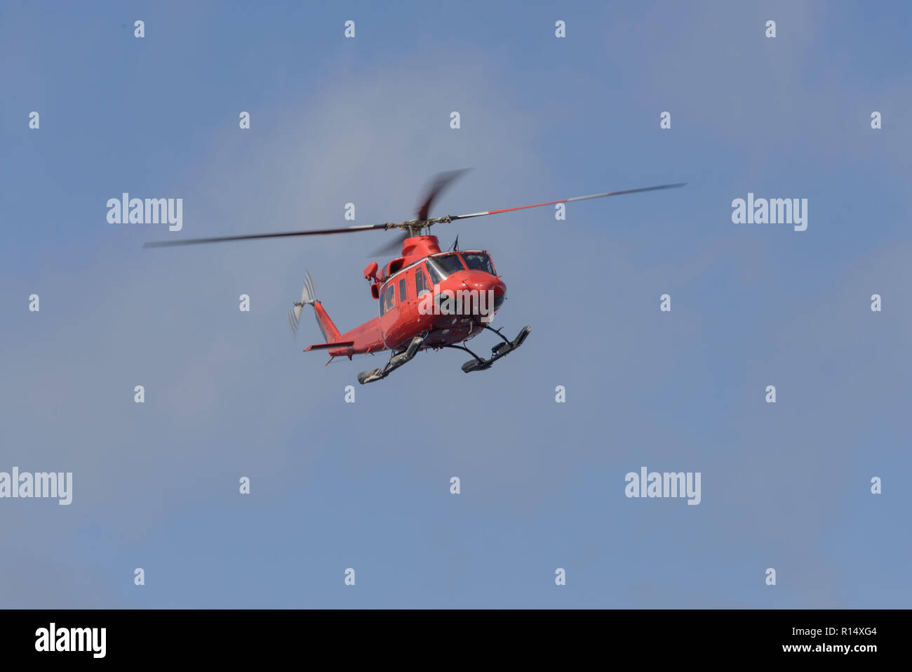 Red helicopter flying Stock Photo - Alamy