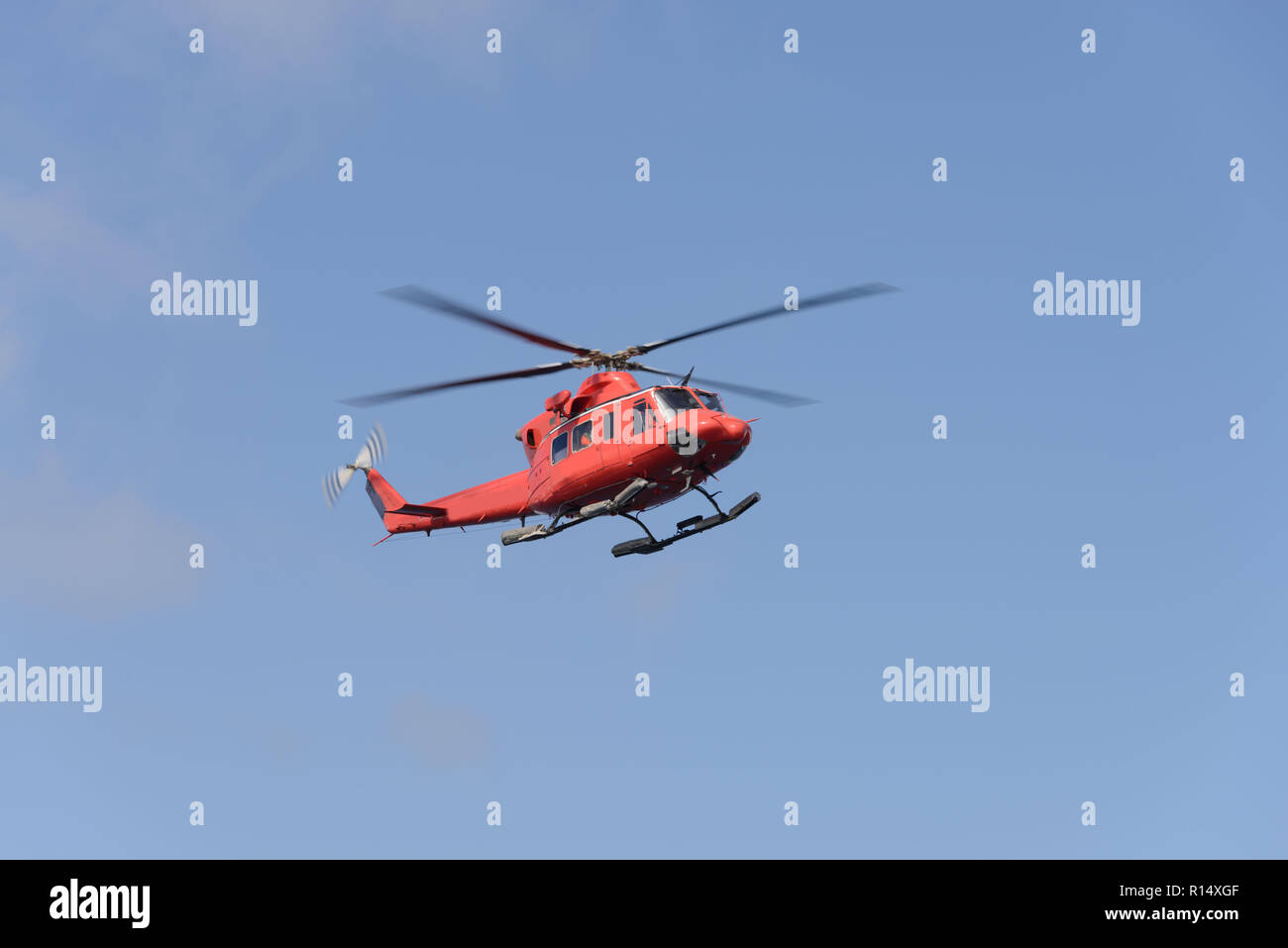 Red helicopter flying Stock Photo - Alamy