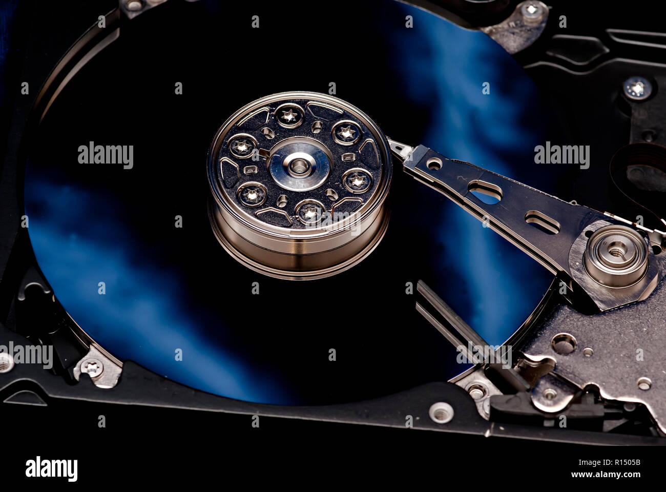 The disassembled hard disk of the computer on a dark blue background ...