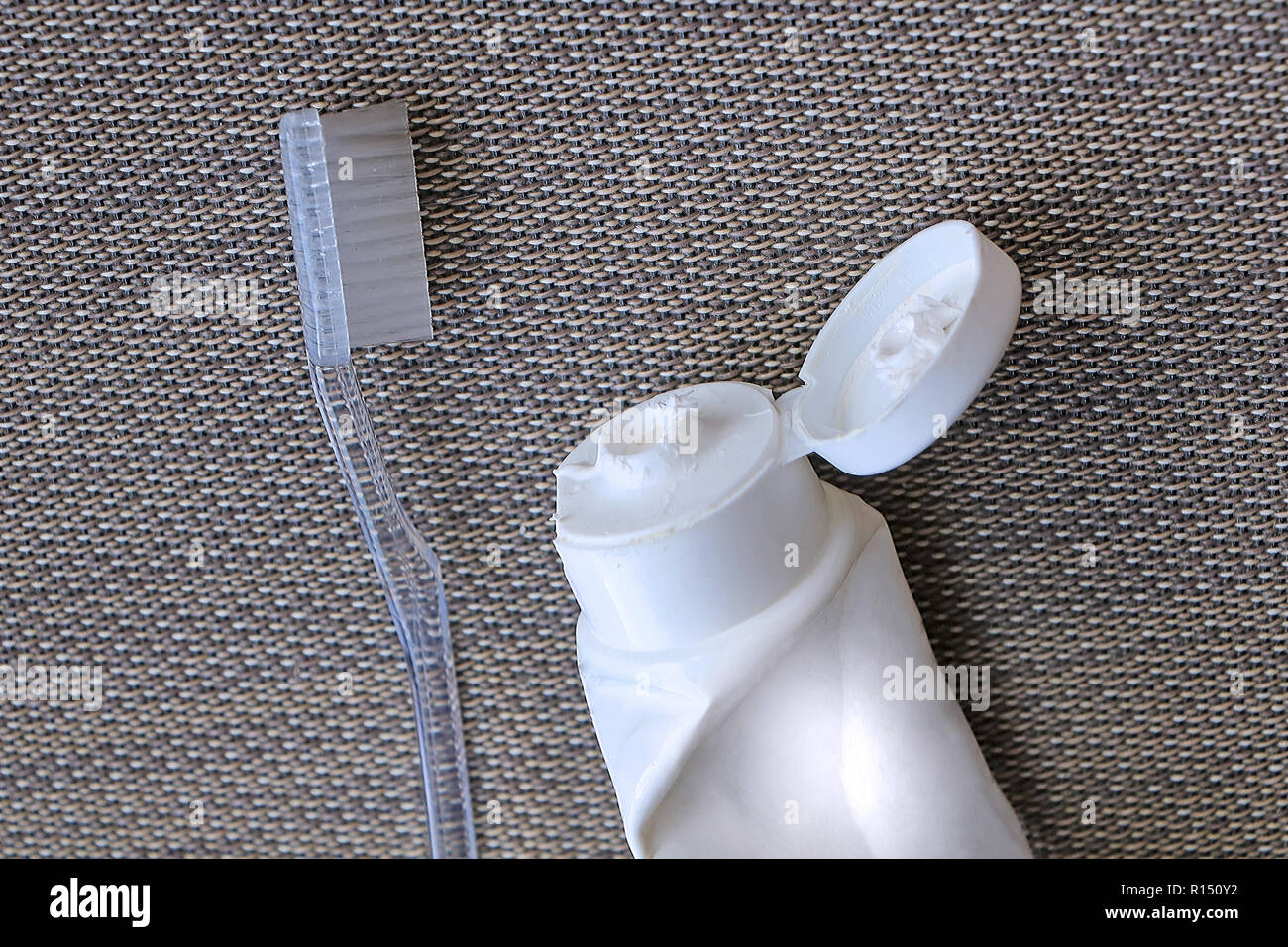 Regular plastic toothbrush next to open lid white toothpaste Stock ...