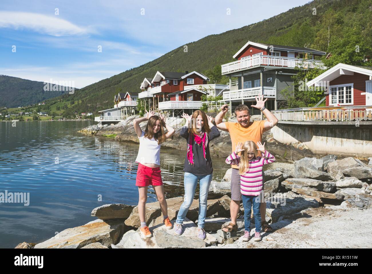 happy family - fun smiling parents and their two daughters near the ...