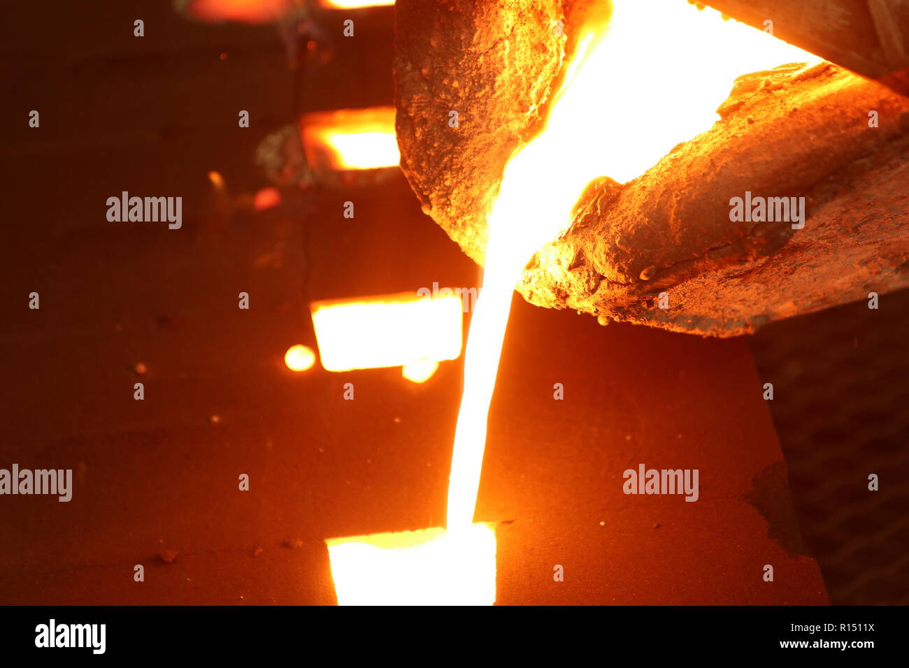 Iron molten metal pouring in sand mold ; green sand process Stock Photo ...