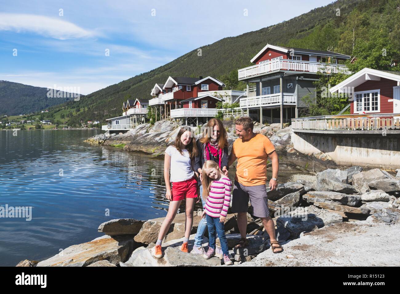 happy family - fun smiling parents and their two daughters near the ...