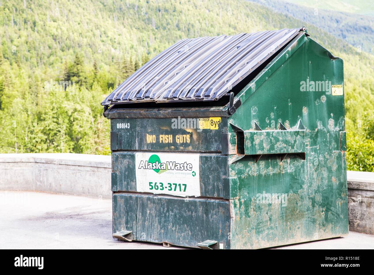 Alaska Waste Dumpster with Sign No Fish Guts Stock Photo - Alamy