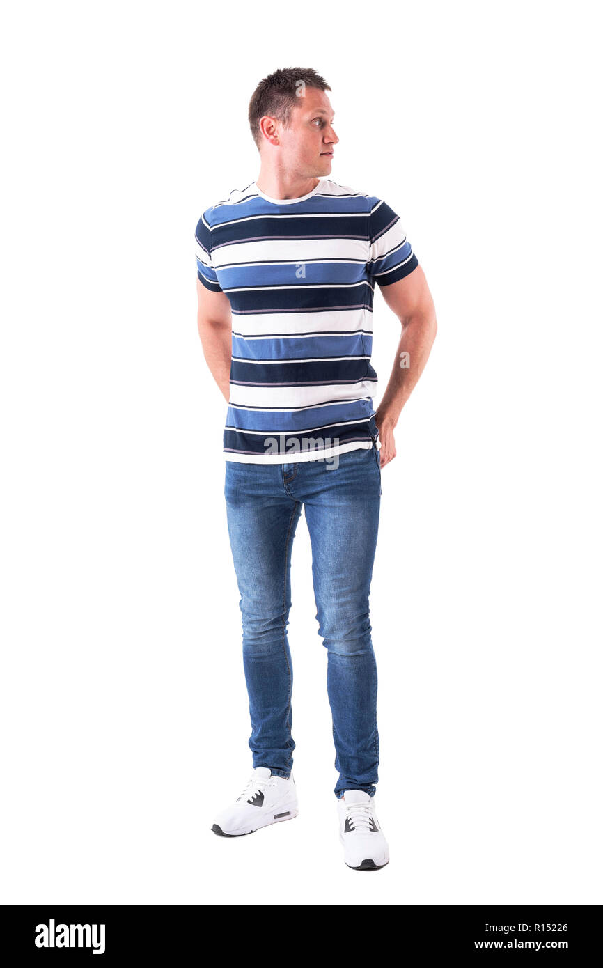 Cool casual adult man with hands on back looking back over the shoulder ...