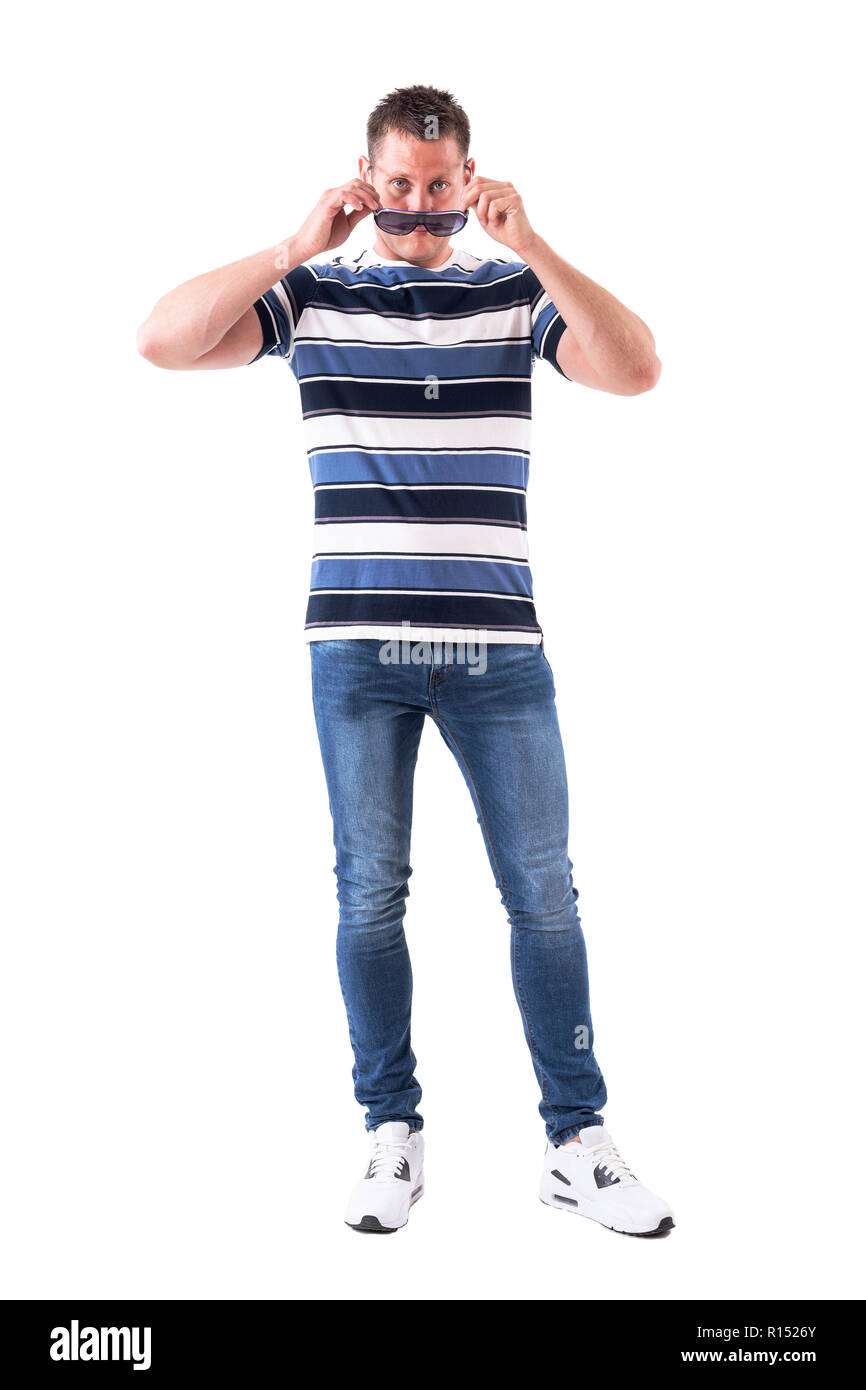 Serious confident adult man applying or taking off sunglasses with ...