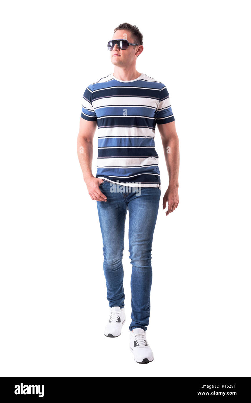 Cool macho male fashion model with sunglasses walking and looking up ...