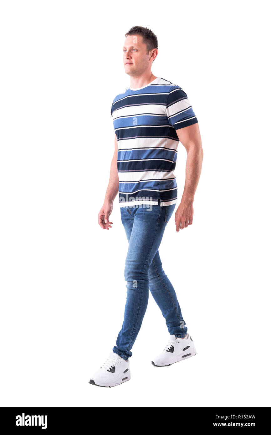 Side view of cool handsome successful man walking and looking away in ...