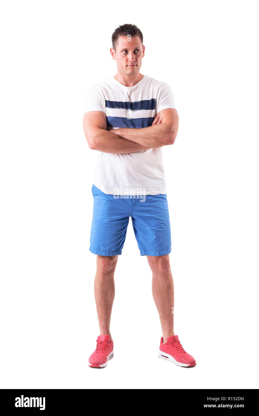Serious thoughtful strong man with crossed arms in sporty summer ...