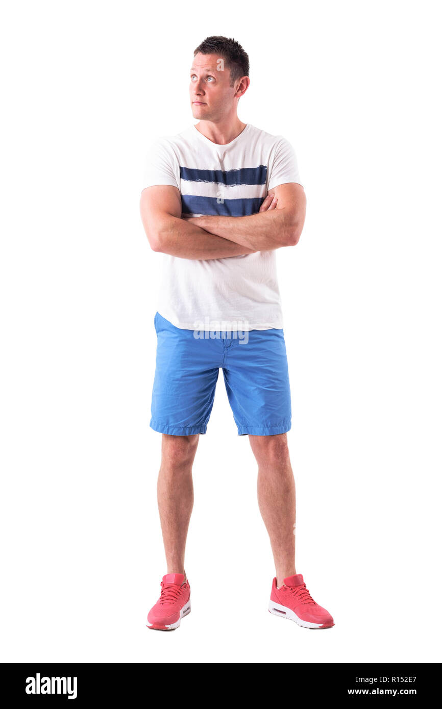 Puzzled confused masculine macho man in sporty summer clothes looking ...