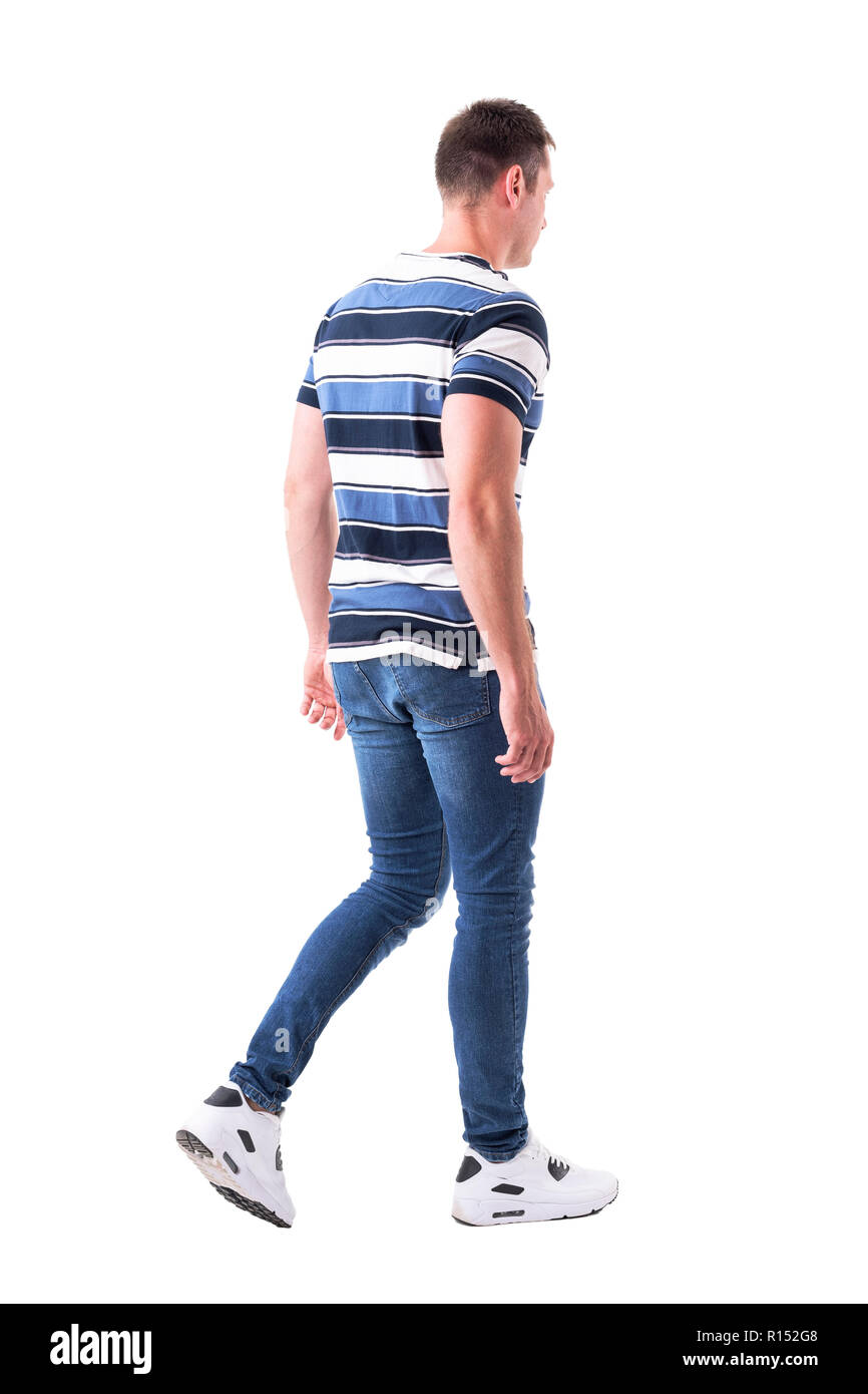 Side view of young casual adult man in jeans walking away. Full body ...