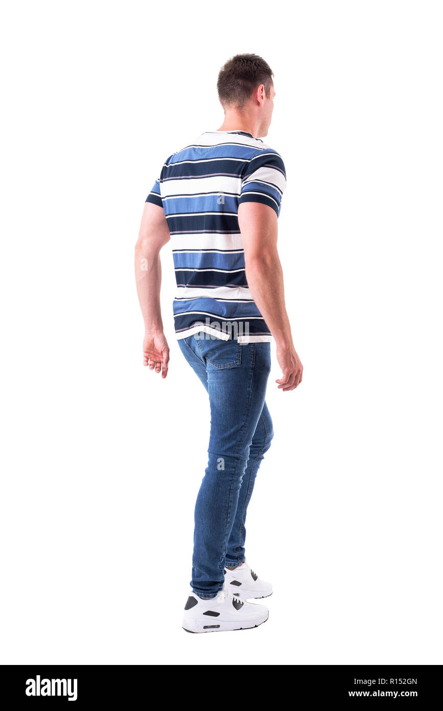 Rear side view of casual young adult man walking or leaving looking ...