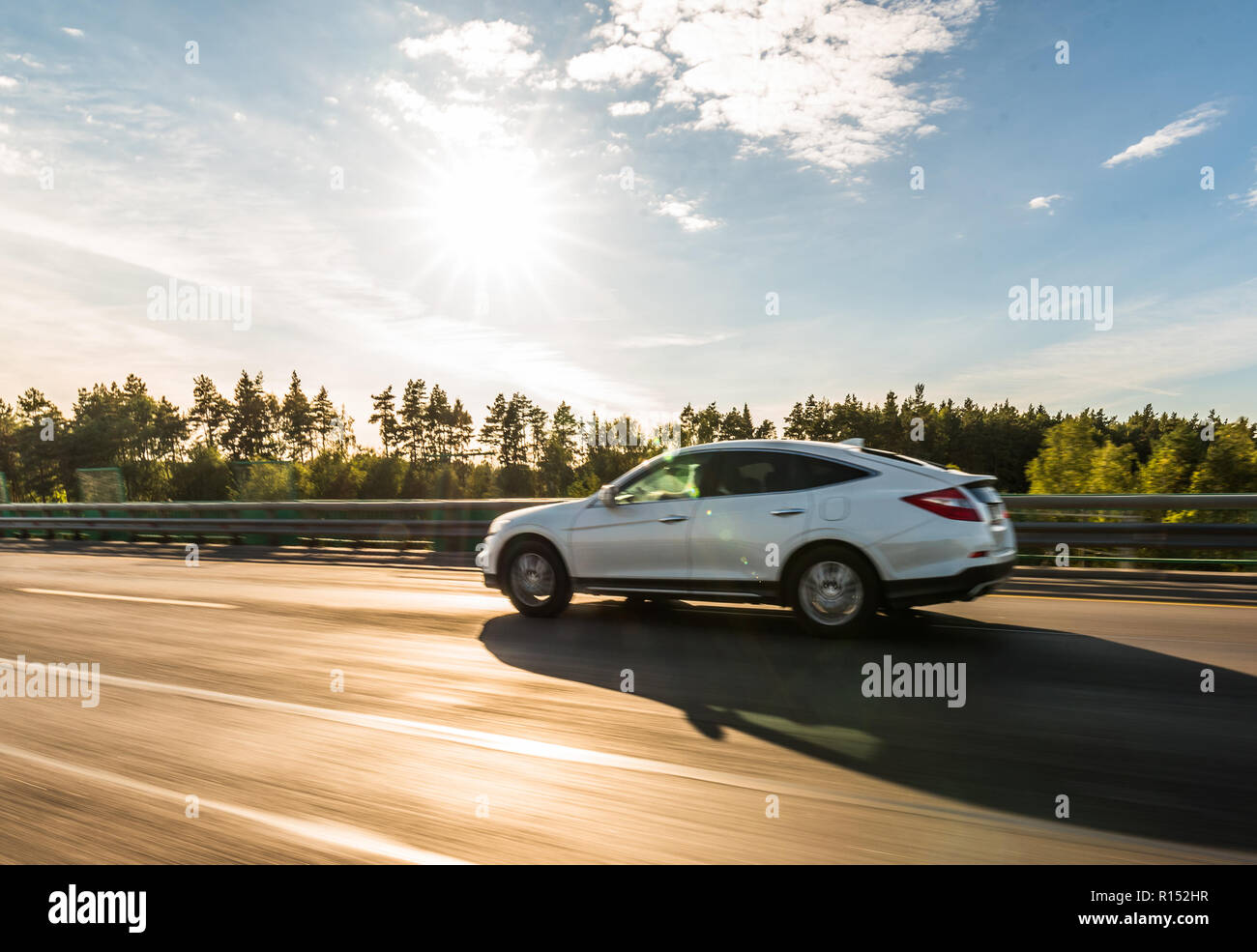 White car on the road with blurred speed effect Stock Photo - Alamy