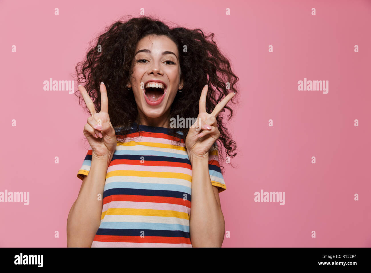 Image of european woman 20s with curly hair shouting and showing peace ...