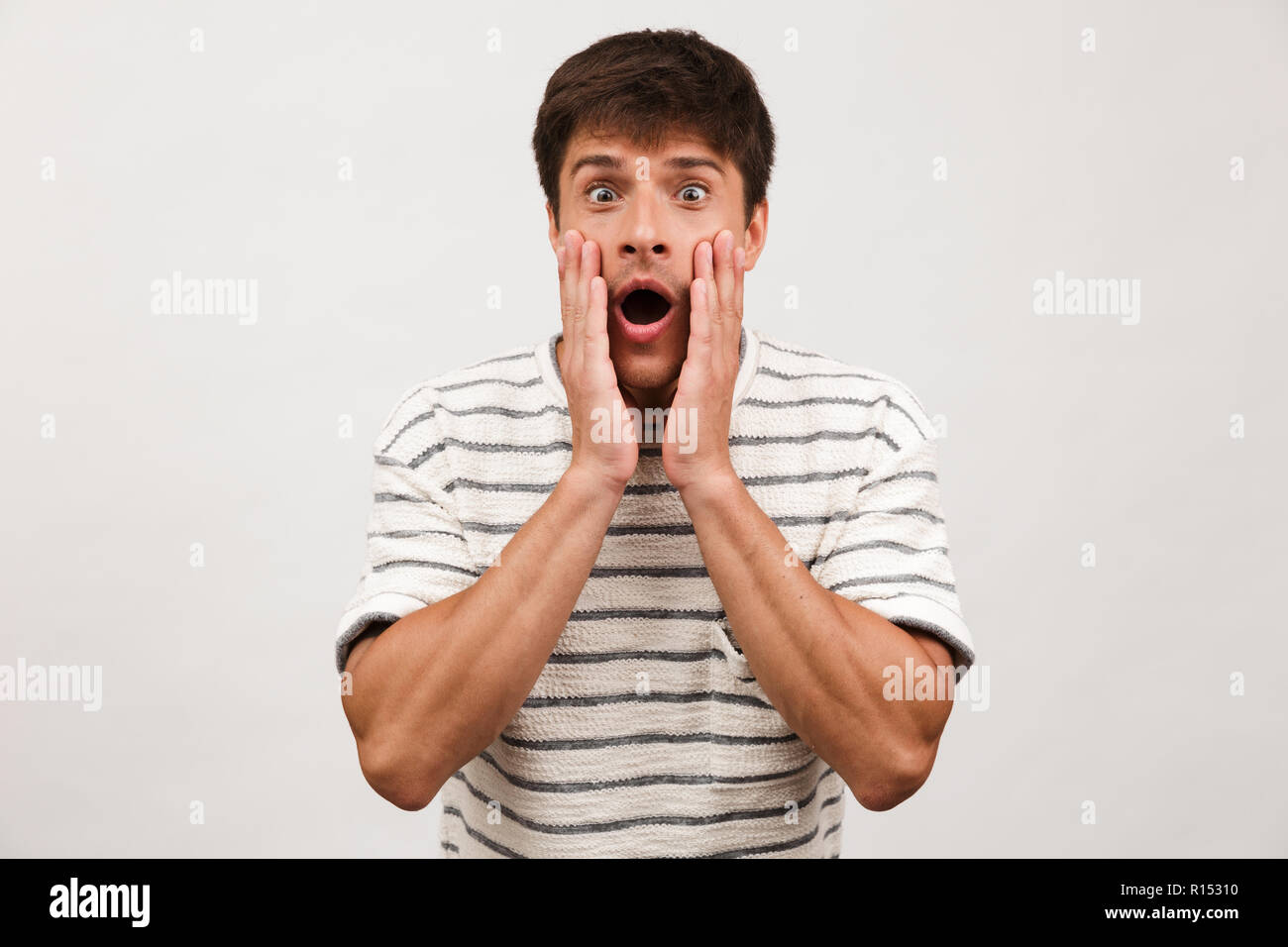 Image of shocked handsome man standing isolated over white background ...